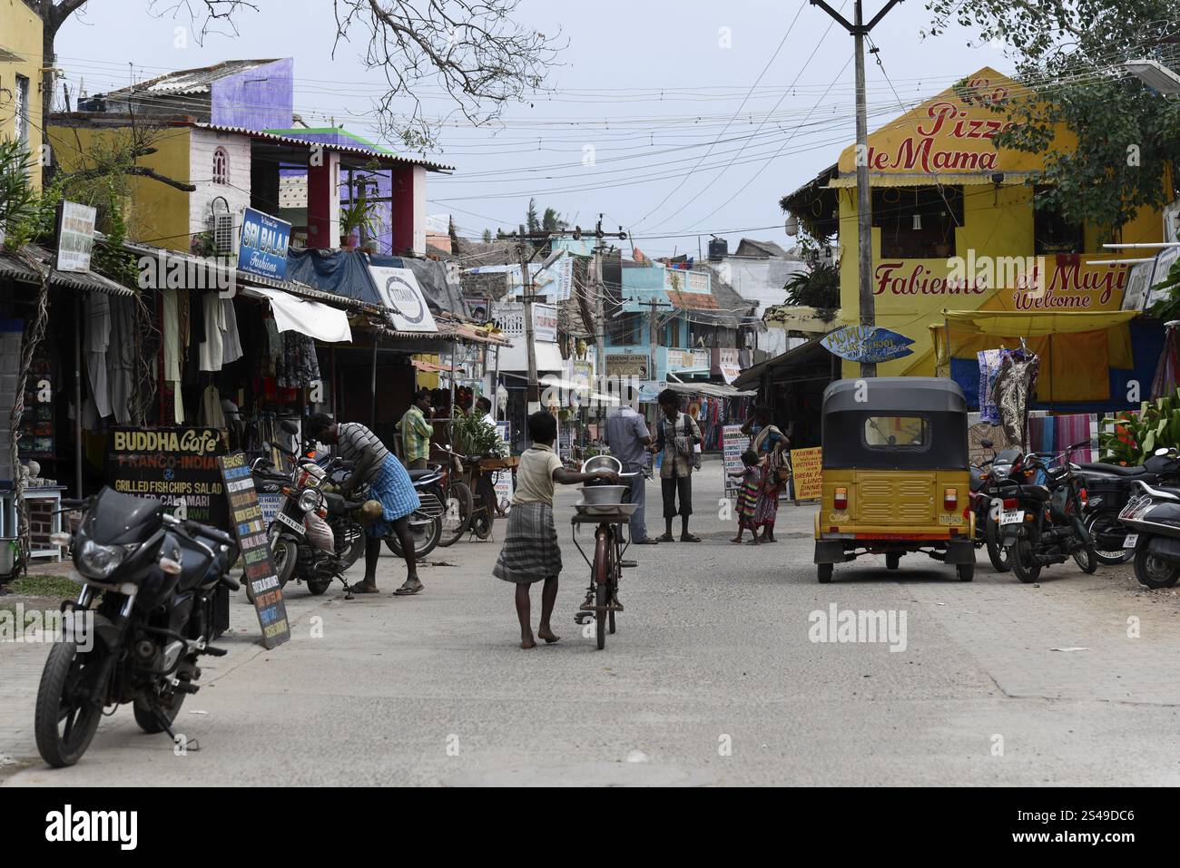Urban scene with people and vehicles on a busy street, Mahabalipuram ...