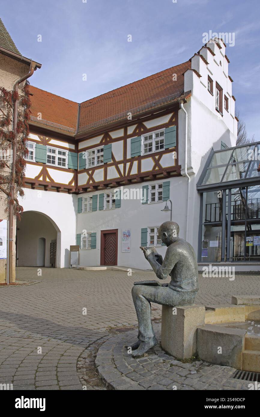 Historic town library with stepped gable and fountain with sculpture of ...