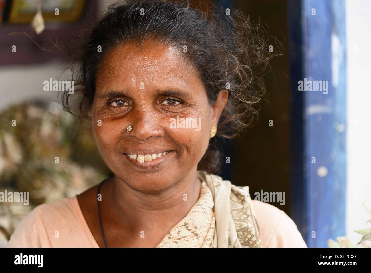 Woman with nose piercing and traditional clothes smiling friendly ...