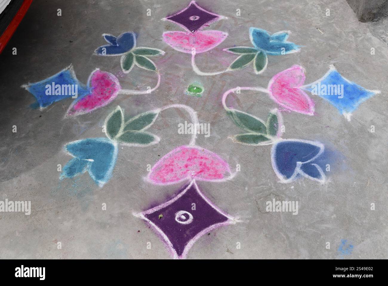 Colourful chalk art on the floor in the form of flowers and shapes ...