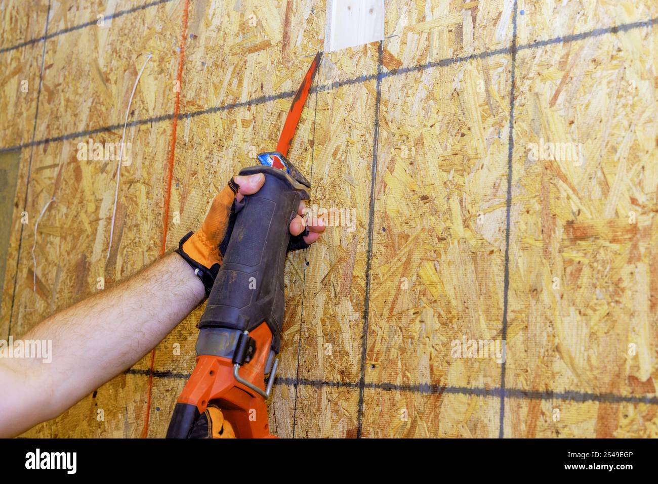 Craftsman using power cutting tool to make precise cuts in an oriented ...