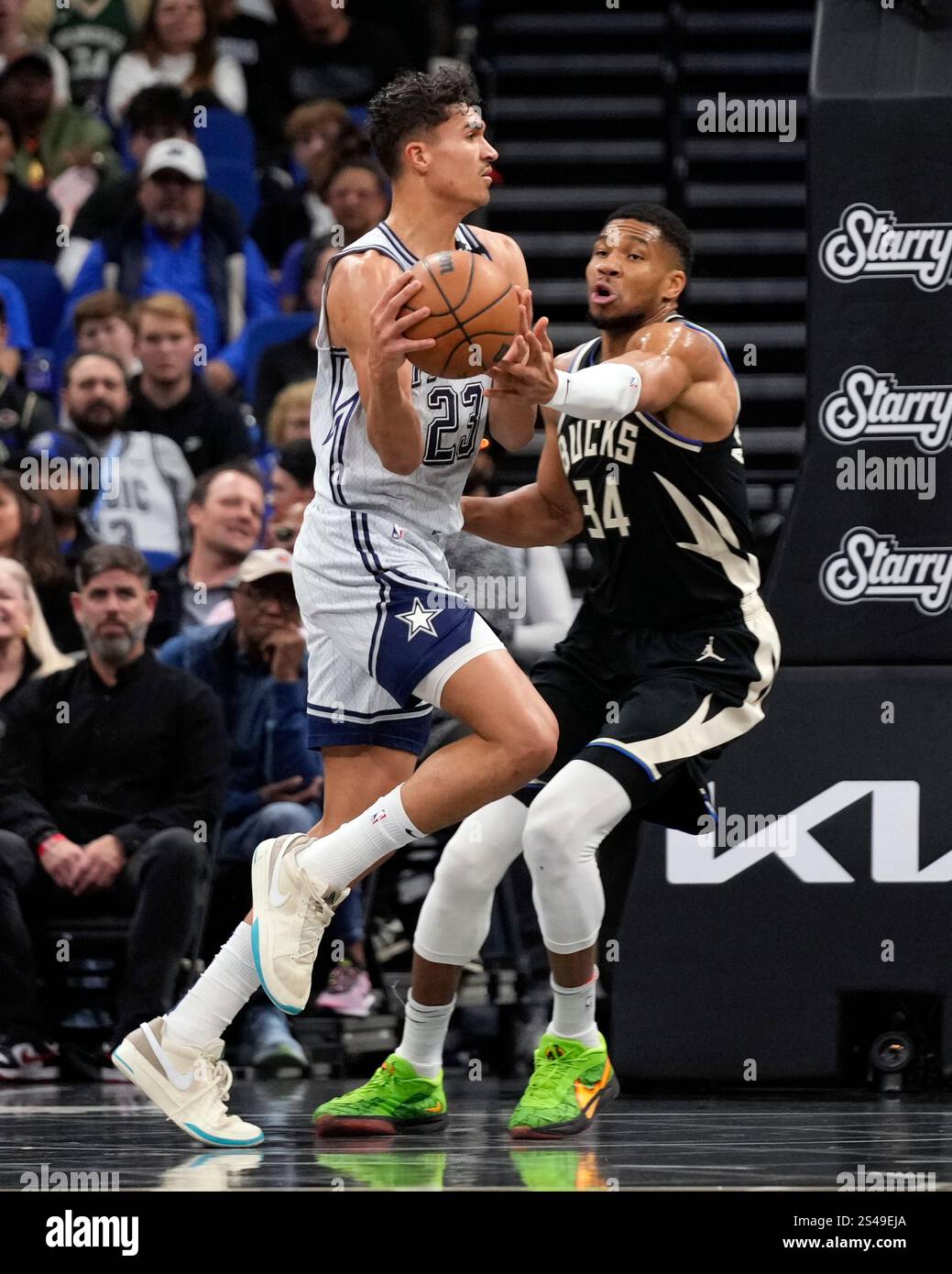 Orlando Magic forward Tristan da Silva, left, passes the ball past Milwaukee Bucks forward ...