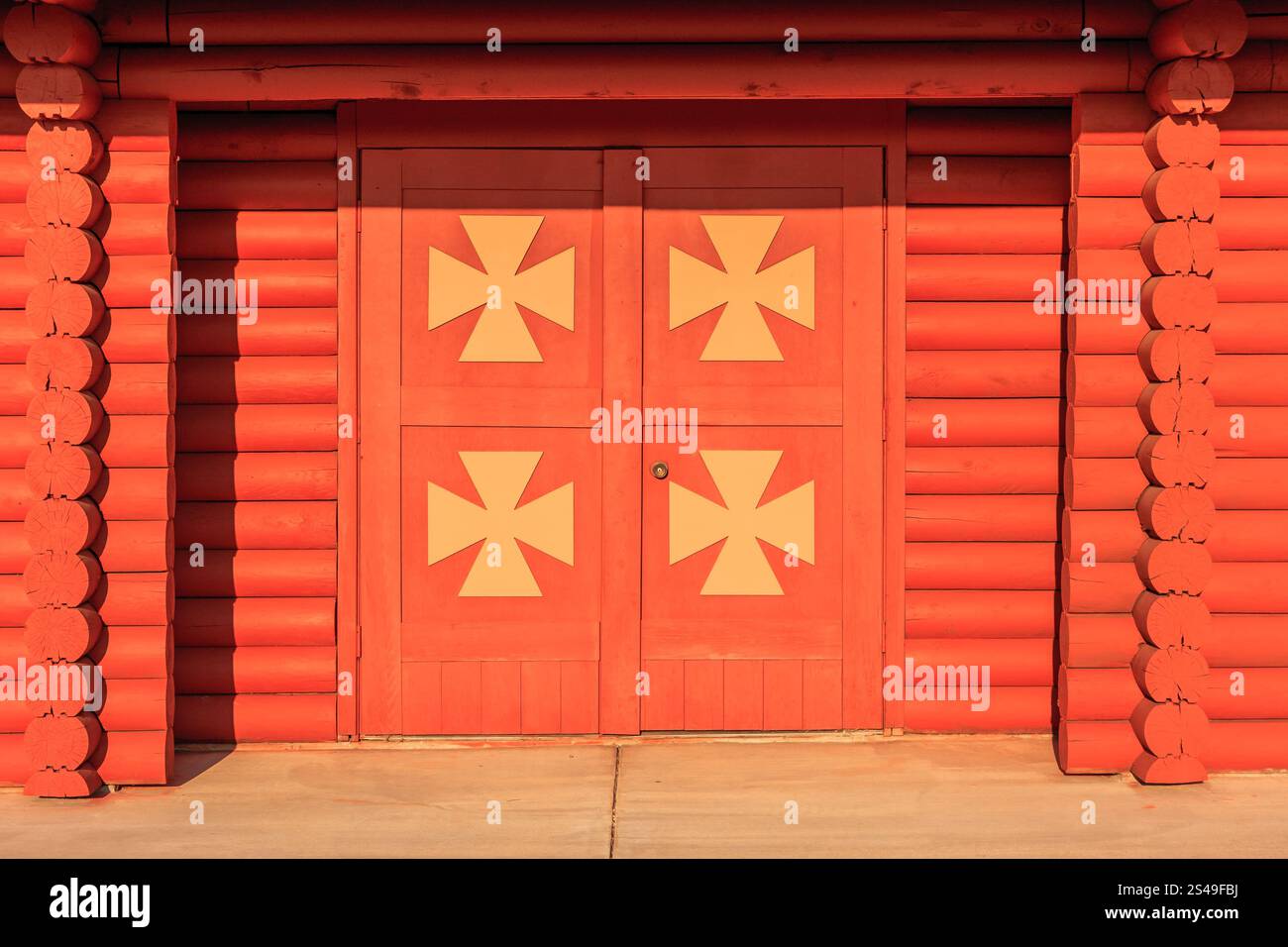 The red door has a cross design on it. The door is open and the inside ...