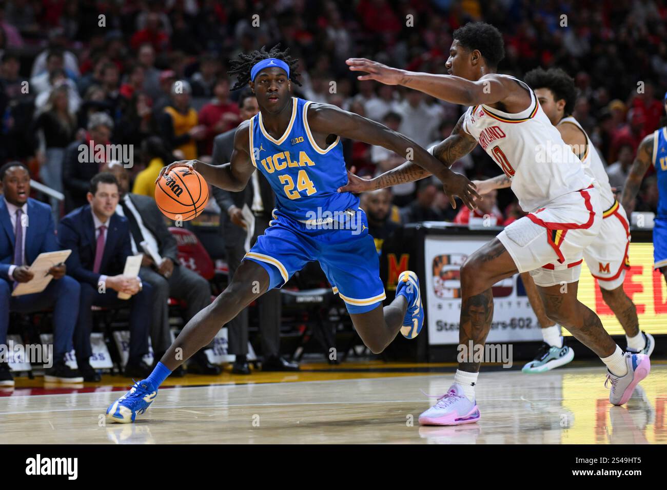 UCLA forward William Kyle III (24) handles the ball as Maryland forward ...