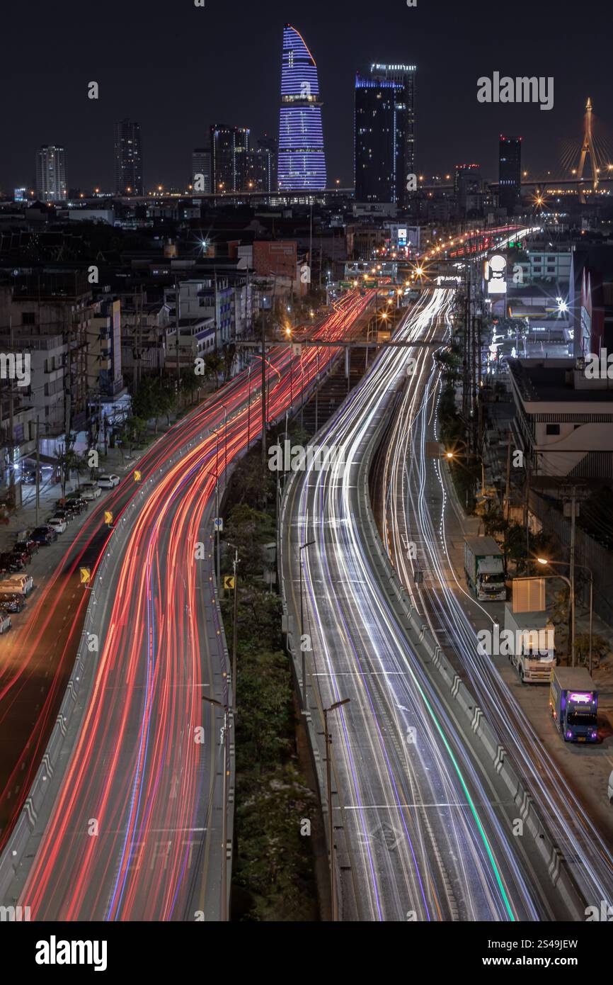 Bangkok, Thailand - Jan 10, 2025 - Nightscape view with bright glowing light trails of many cars ...