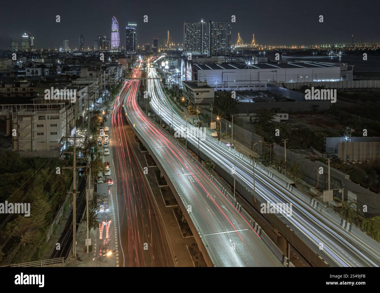 Bangkok, Thailand - Jan 10, 2025 - Nightscape view with bright glowing light trails of many cars ...