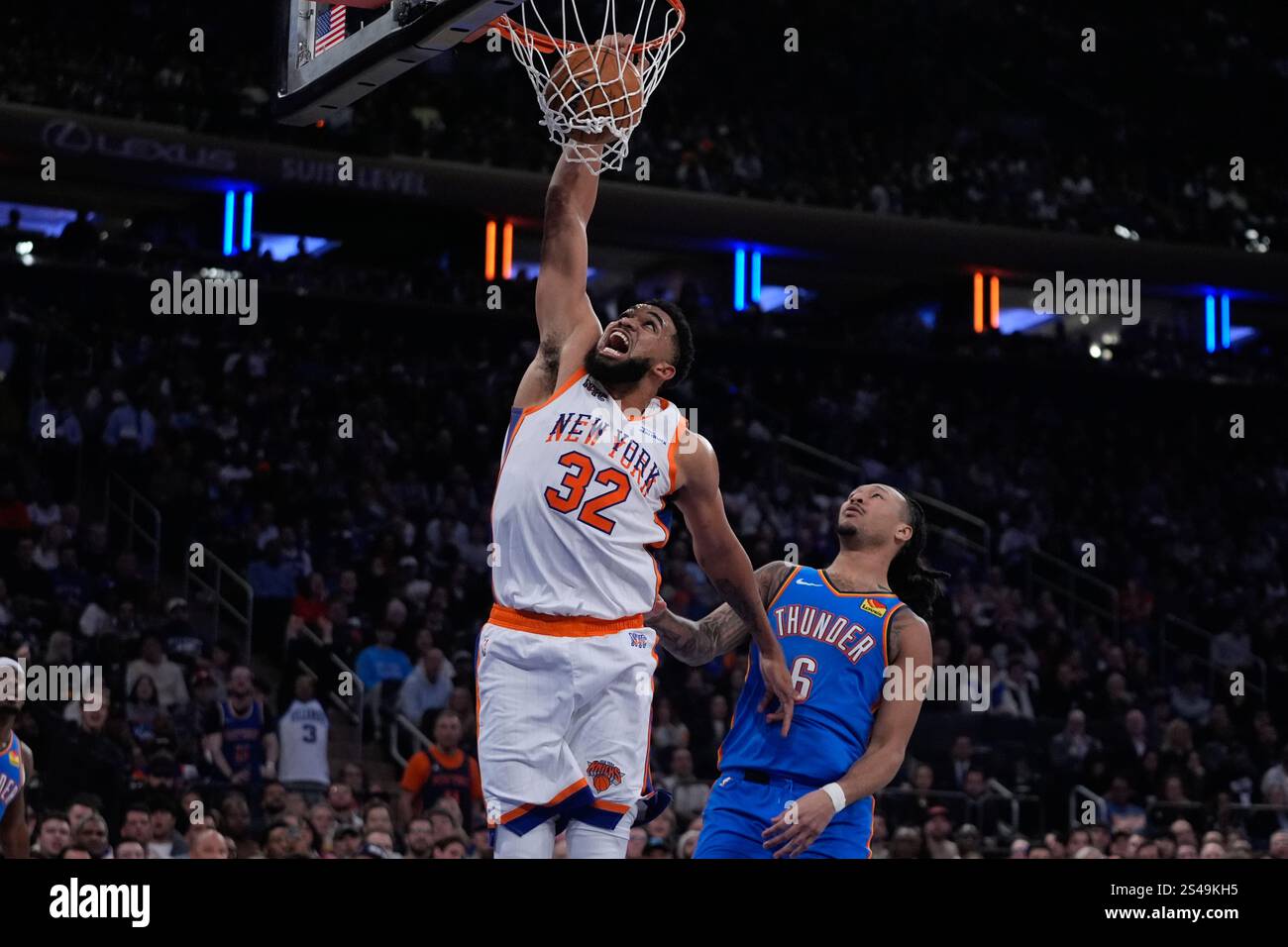 New York Knicks' Karl-Anthony Towns (32) dunks the ball in front of ...