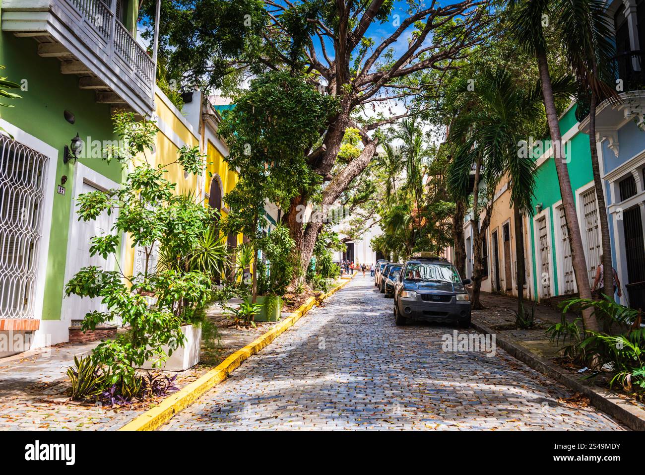 San Juan, Puerto Rico - February 25, 2018: Calle Caleta de San Juan is a tree lined cobblestone ...