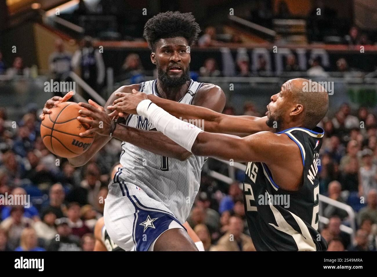 Orlando Magic forward Jonathan Isaac, left, passes the ball around ...
