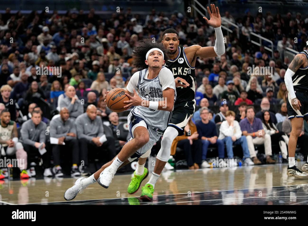 Orlando Magic guard Anthony Black, left, drives to the basket in front ...