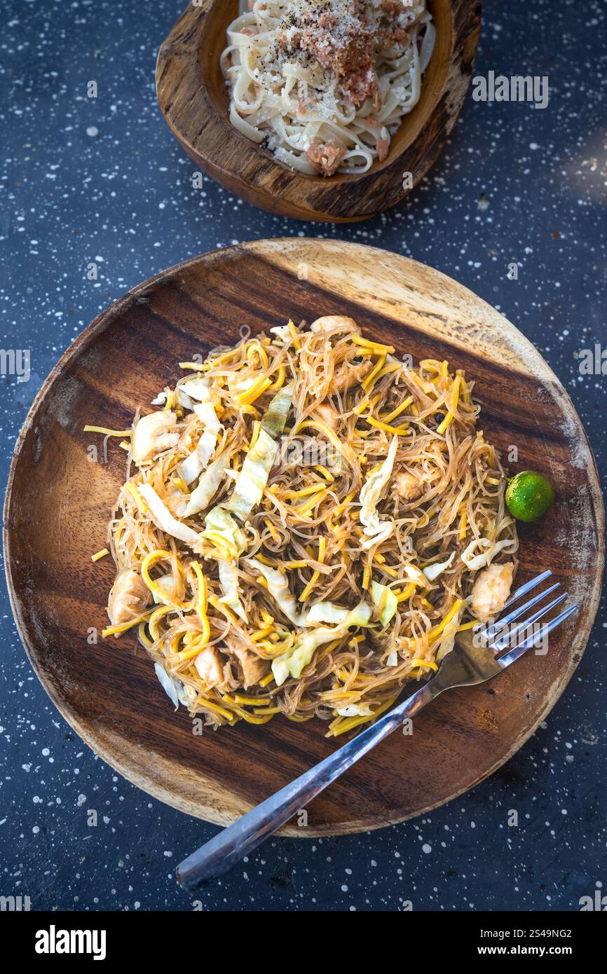 Delicious plate of traditional Filipino Pancit, served on a rustic ...