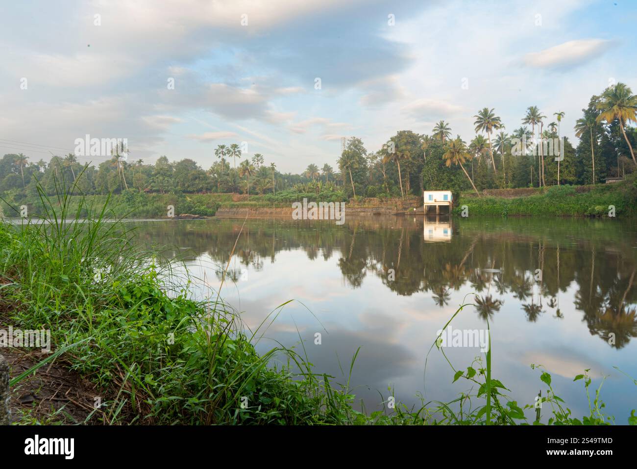 A beautiful scenery of landscape with river, sky in village in Kerala ...