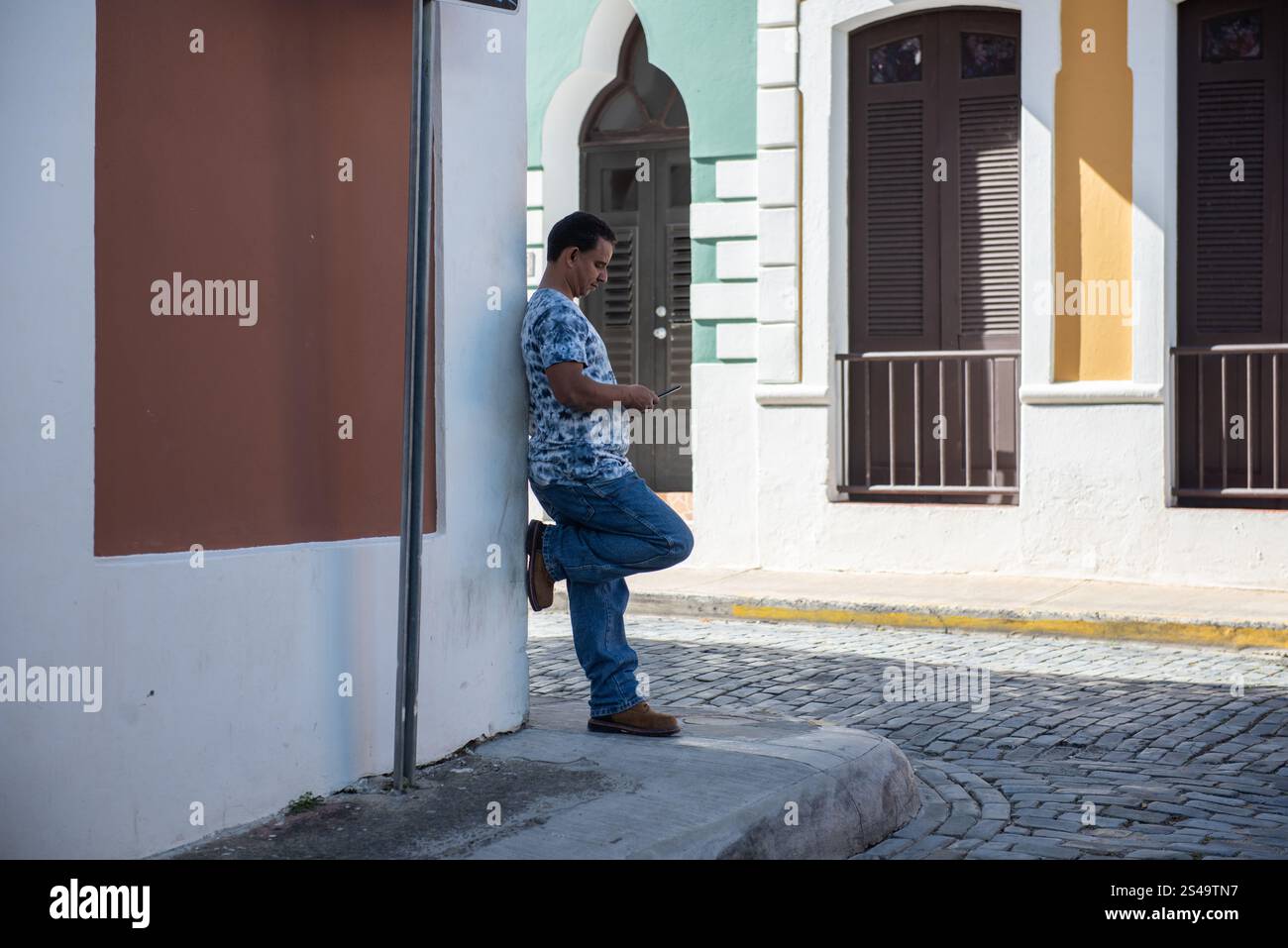 San Juan, Puerto Rico - February 27, 2018: Puerto Rican man checks his ...