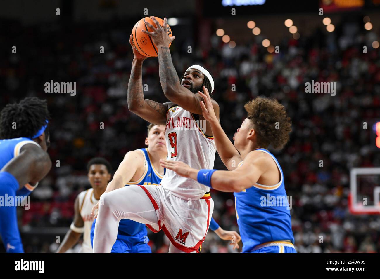 Maryland guard Selton Miguel (9) drives to the basket and shoots the ...
