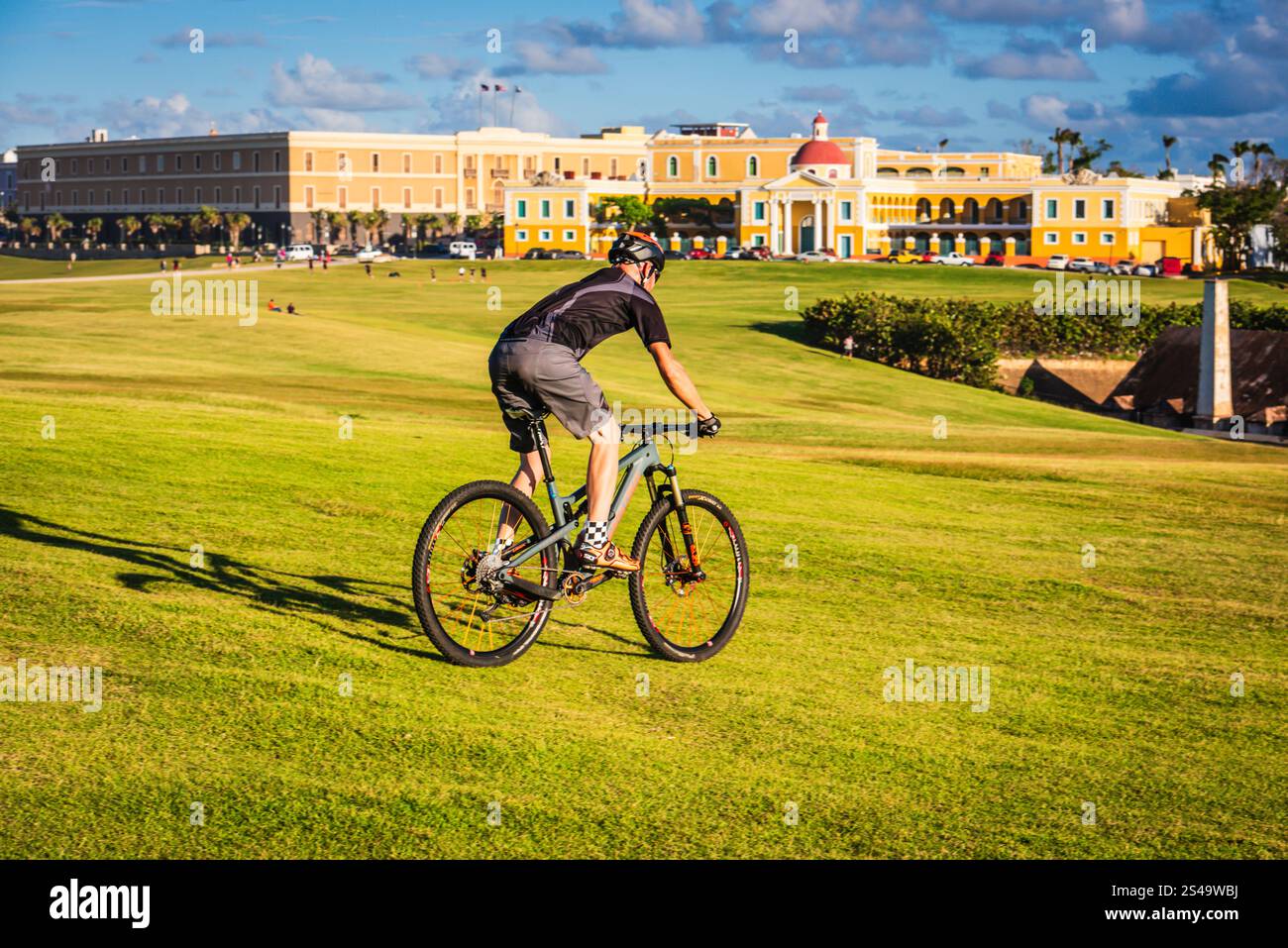 San Juan, Puerto Rico - February 27, 2018: Man rides bike on field in ...