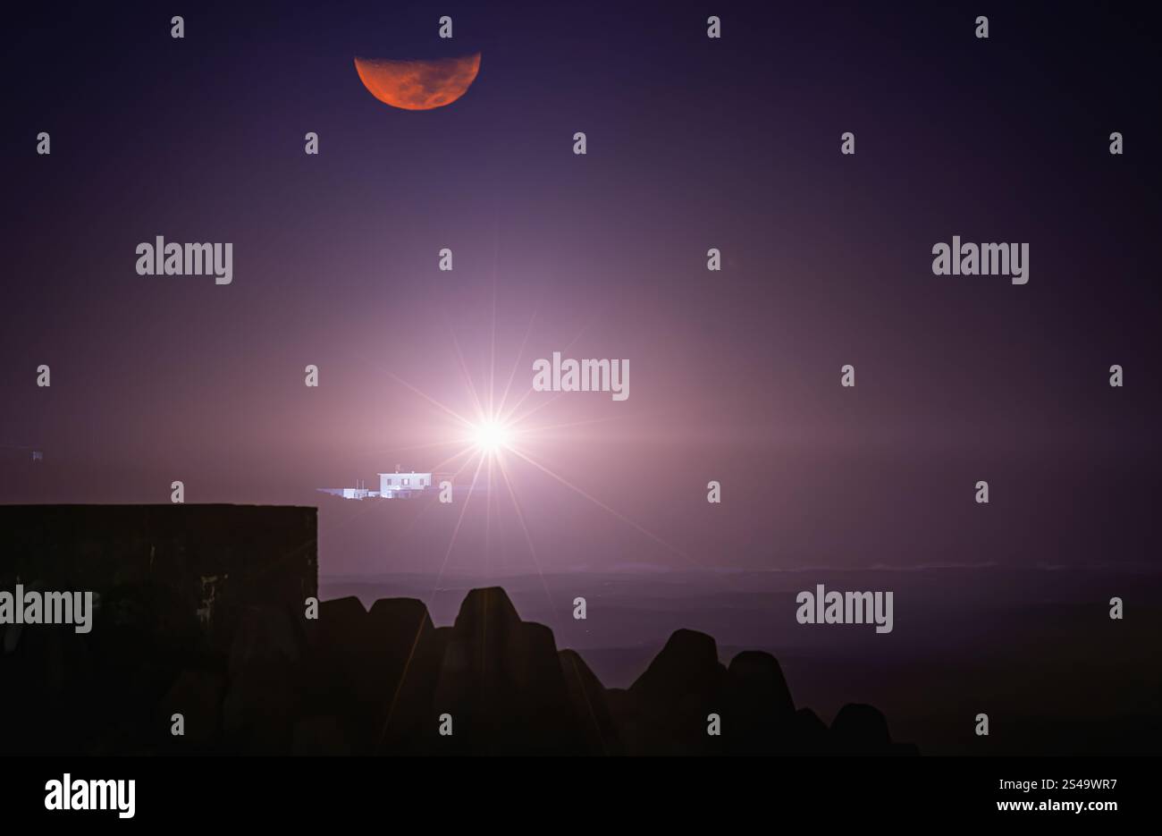 A bright red moon illuminates the night sky above the Fugui Cape ...