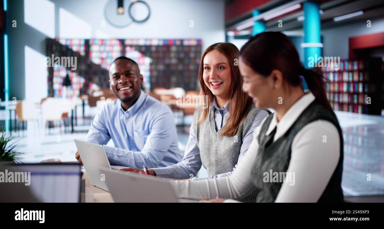 Students Learning Online At University Library Using Laptops Stock ...
