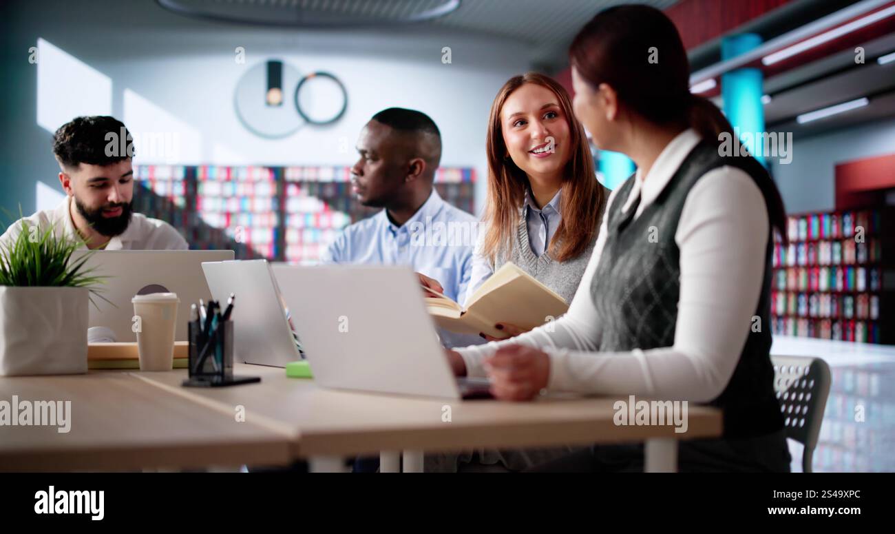 Students Learning Online At University Library Using Laptops Stock ...