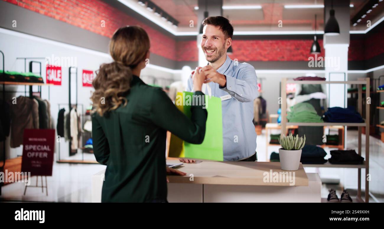 Cashier Retail Assistant At Cloth Store Counter Stock Photo - Alamy