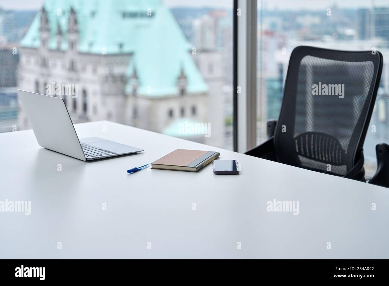 Open laptop on work table, computer at desk in skyscraper office ...