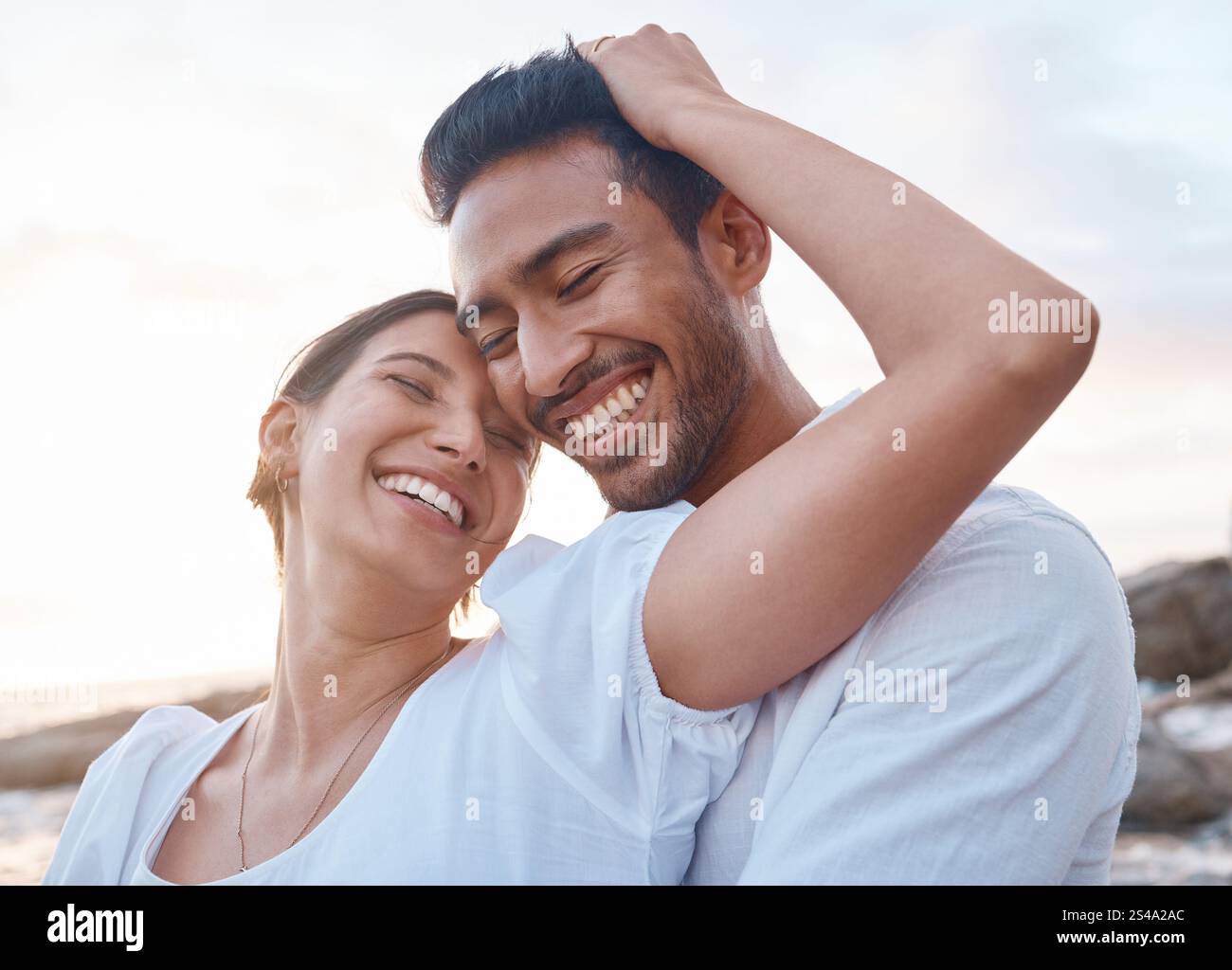 Couple, hug and smile with love, beach and memory with adventure, happy or bonding on vacation ...