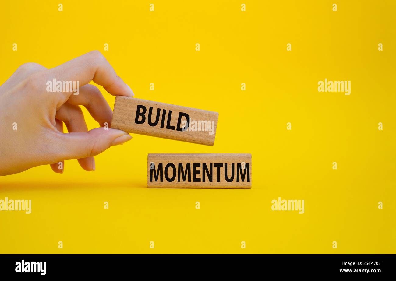 Build momentum symbol. Wooden blocks with words Build momentum ...