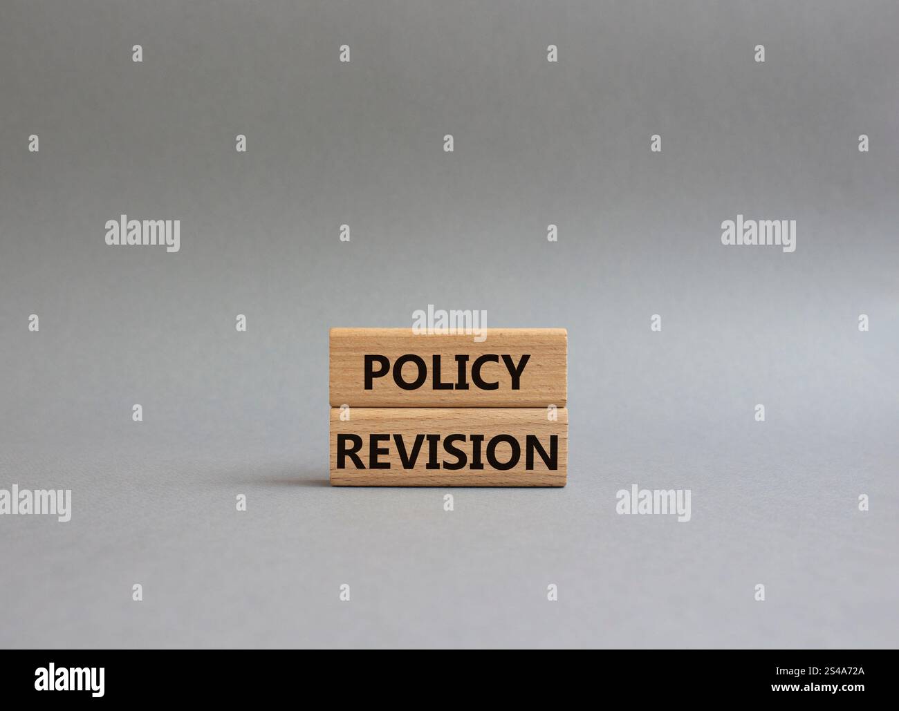 Policy revision symbol. Concept word Policy revision on wooden blocks ...