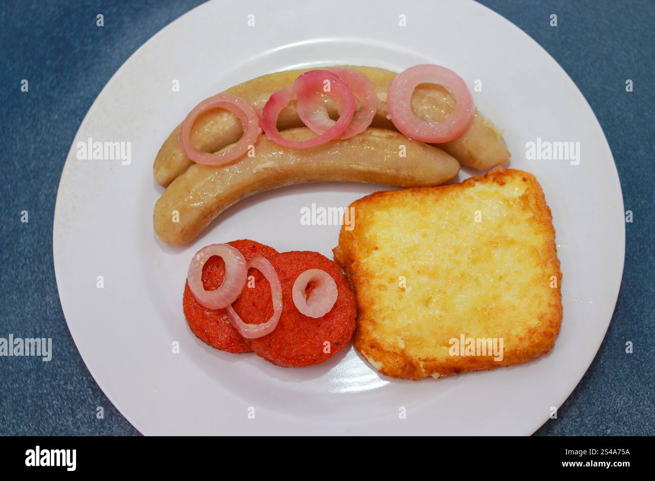 traditional dominican dish of guineitos with salami and fried cheese ...