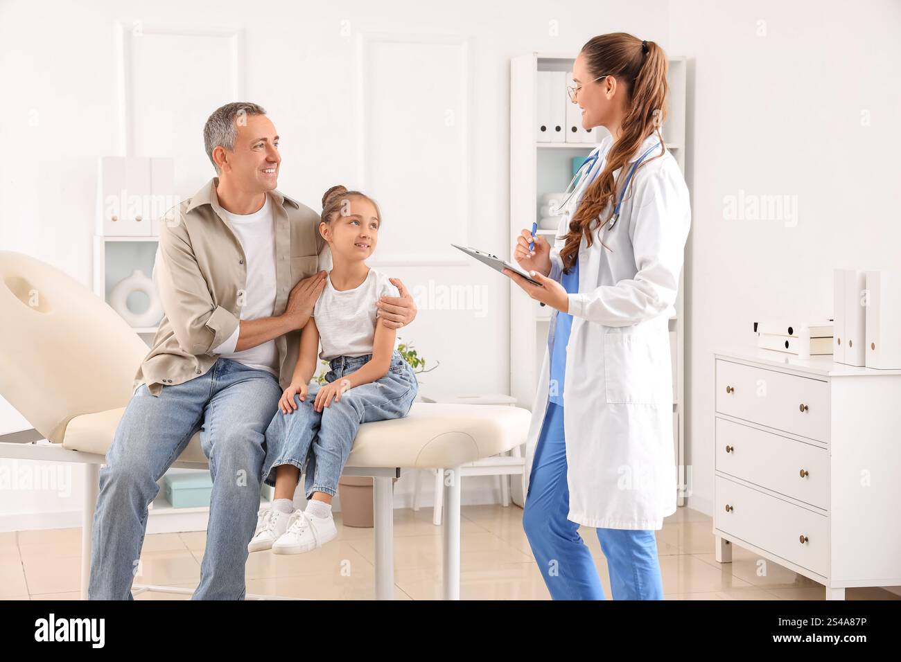 Little girl with her father visiting pediatrician in clinic Stock Photo ...