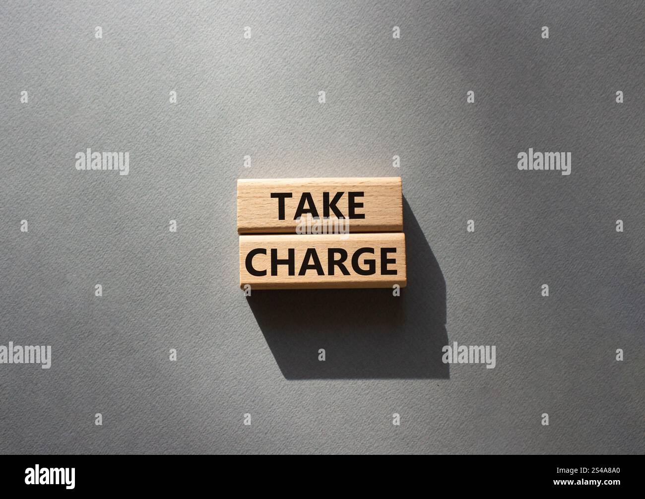 Take charge symbol. Wooden blocks with words Take charge. Beautiful ...