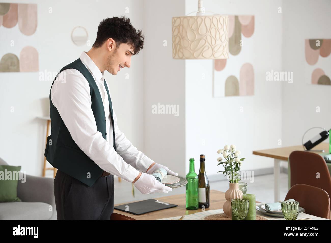 Young worker table setting hi-res stock photography and images - Alamy