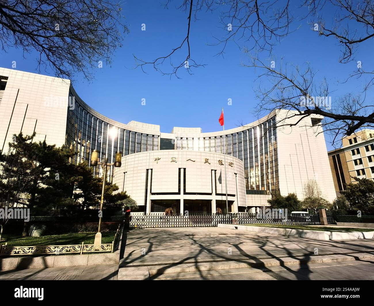 A citizen passes the headquarters building of the People's Bank of ...