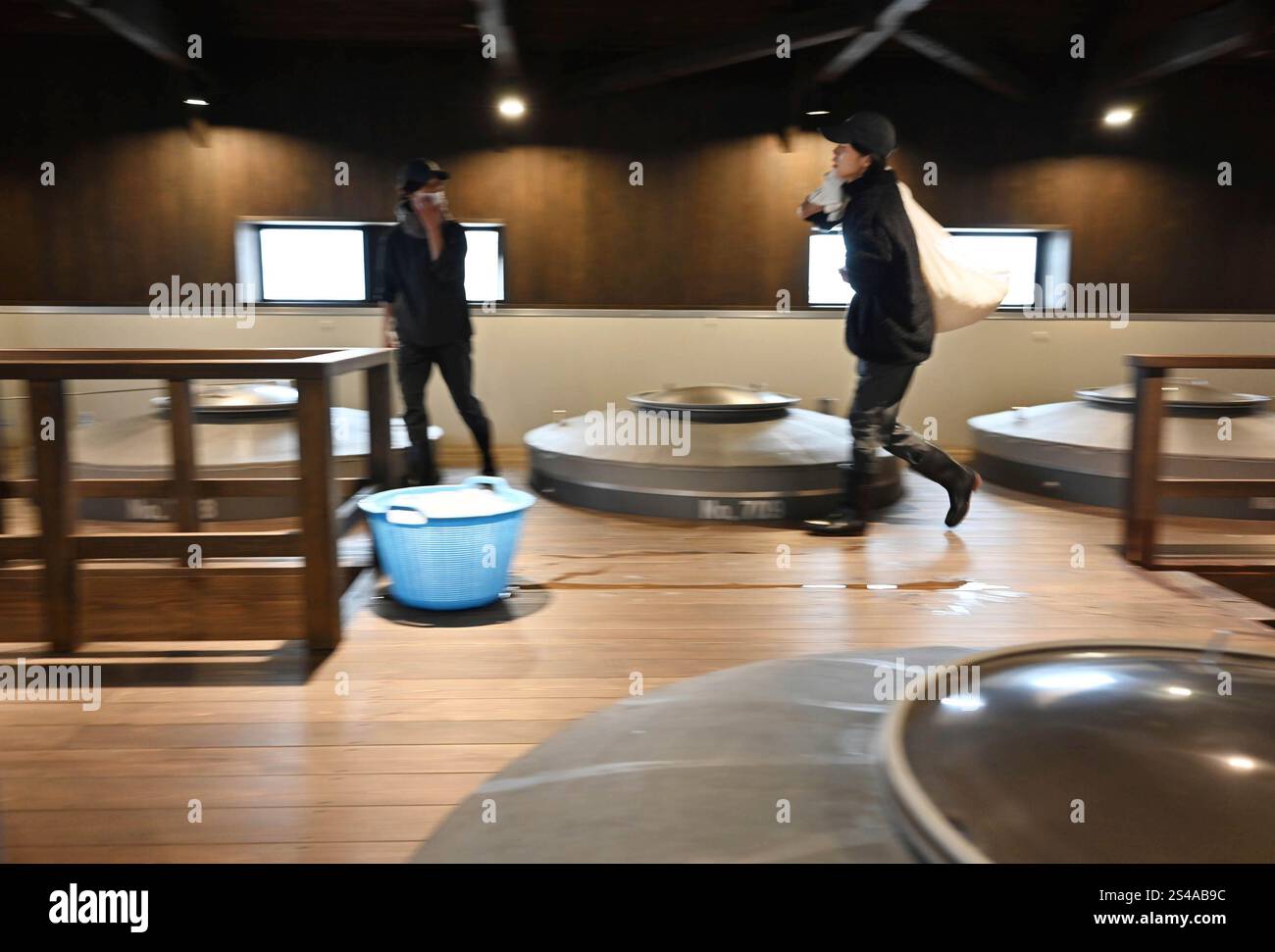 Kurabito brewer carries steamed rice at Yoshida Shuzoten Co.in Hakusan ...