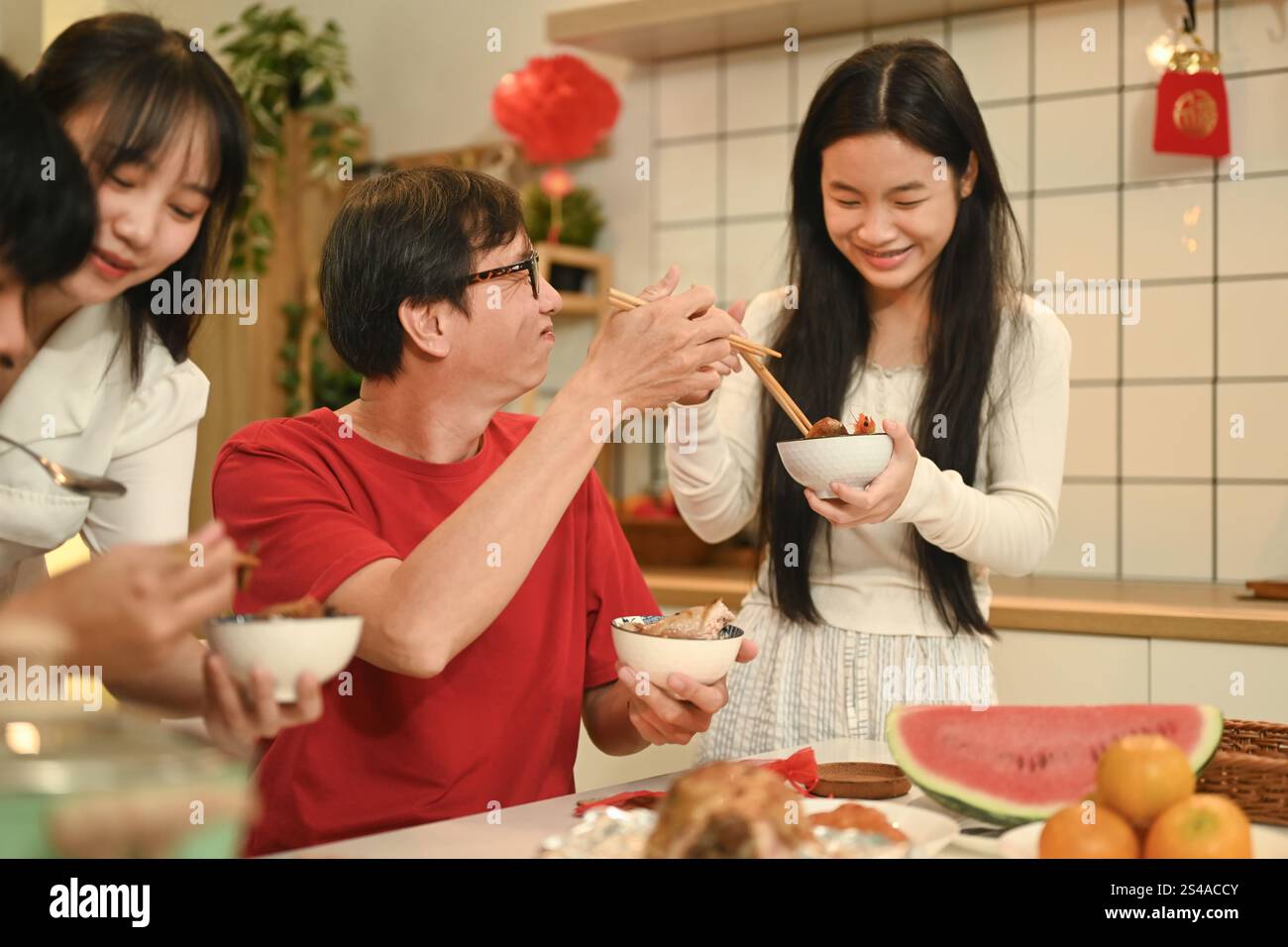 Warm asian family enjoying traditional dishes during Chinese New Year ...