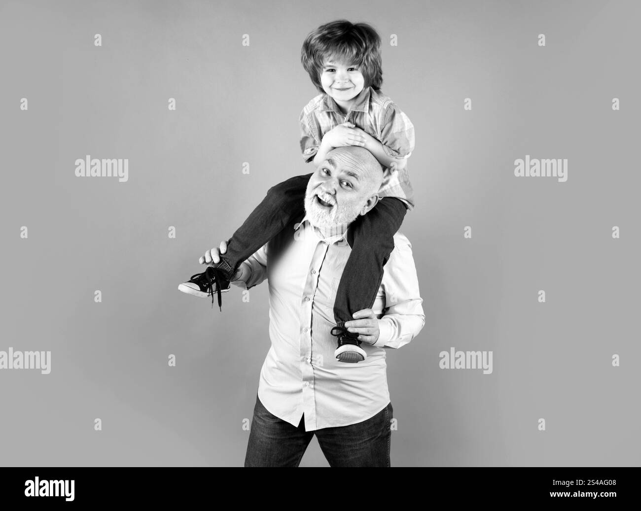 Grandson child and grandfather piggyback ride with funny face isolated ...