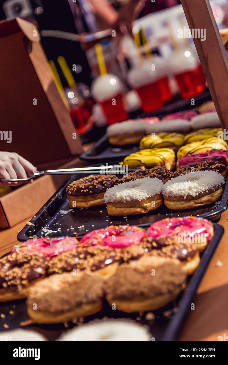 Donuts are on the counter of the store, street food desserts are sold ...