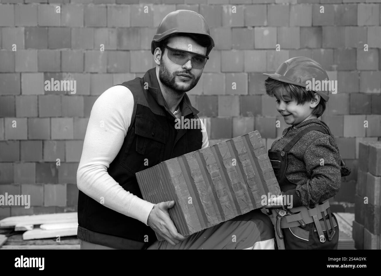 Brothers helping concept. Bricklayer installing bricks on construction ...