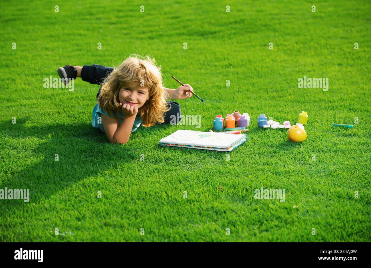 Young talented boy artist painter. Child boy painting with paints color ...