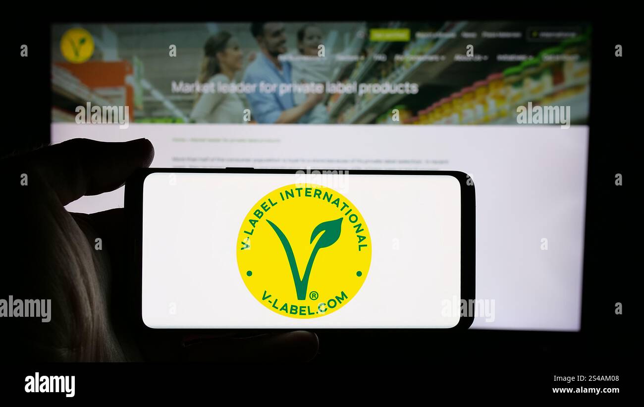 In this photo illustration, a person is holding a cellphone with the ...