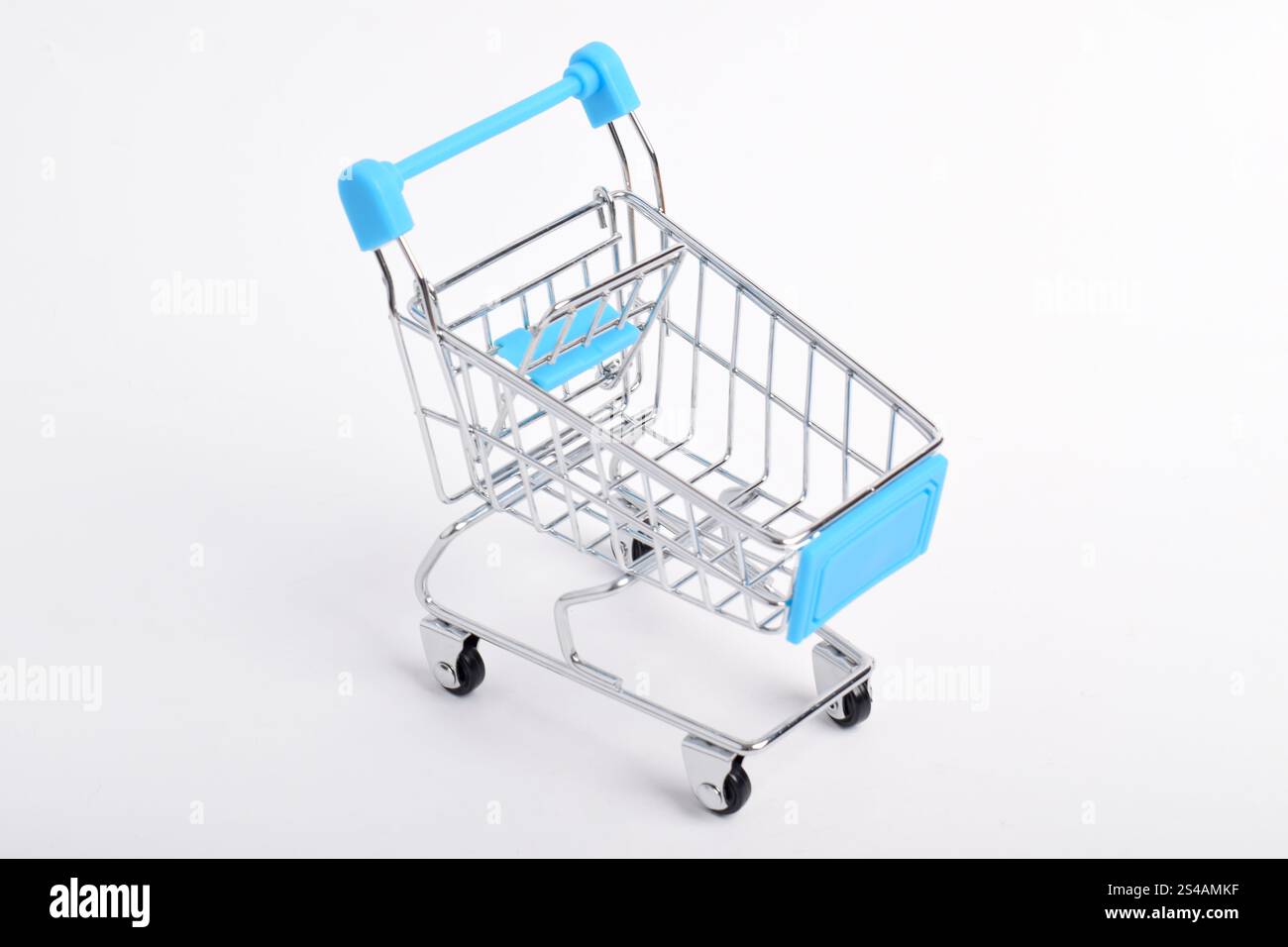 Mini model of blue shopping cart isolated on white background. Shopping ...