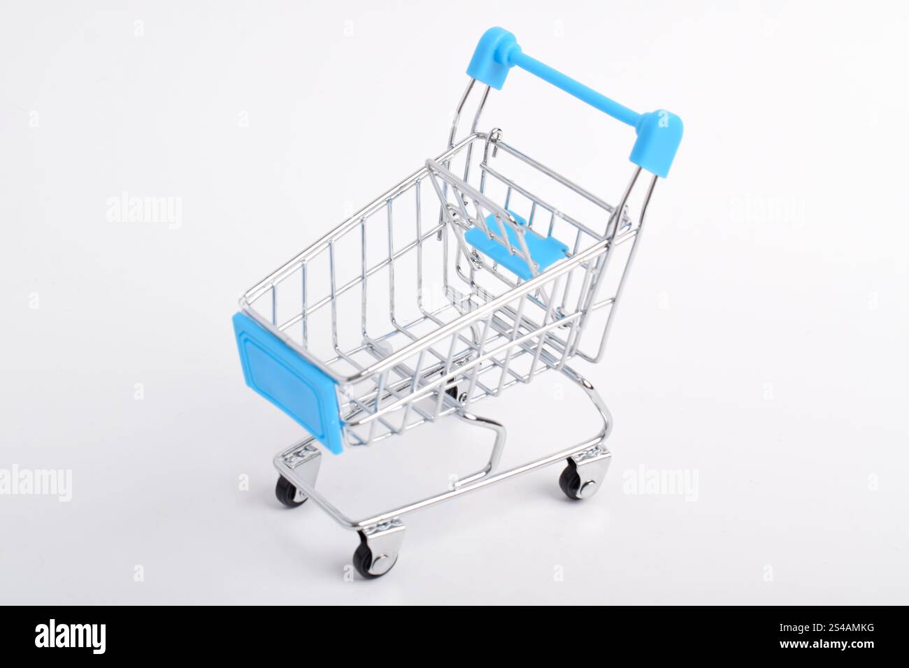 Mini model of blue shopping cart isolated on white background. Shopping ...