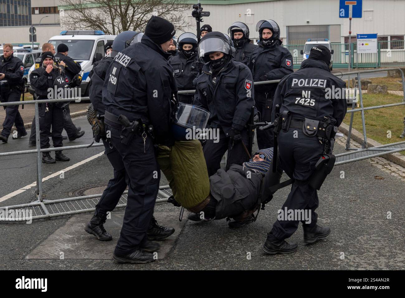 Police officers remove a protestor from the street during a ...
