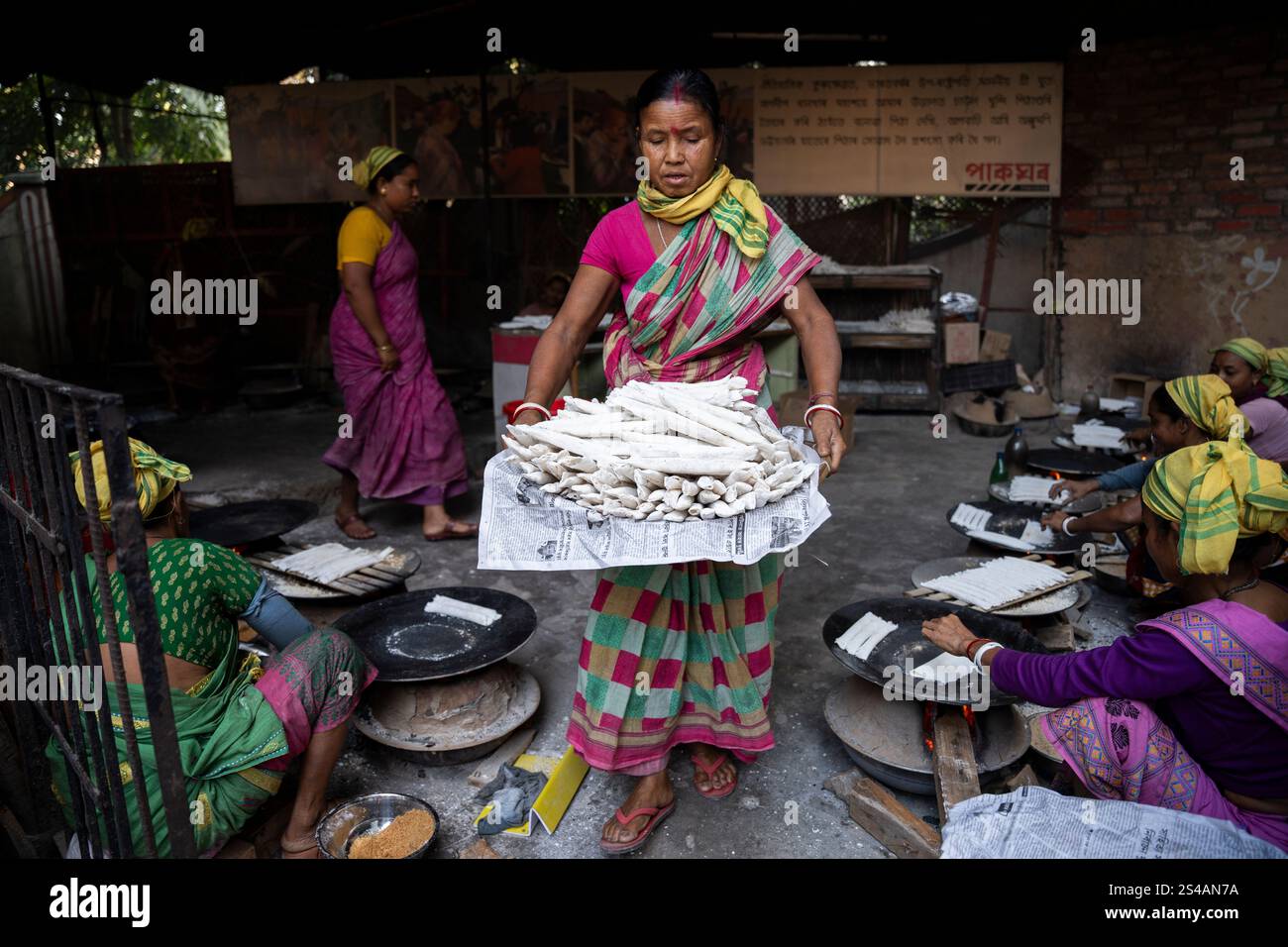 Women makes Assamese traditional food Pitha to sell at Bipanan Khetra ...