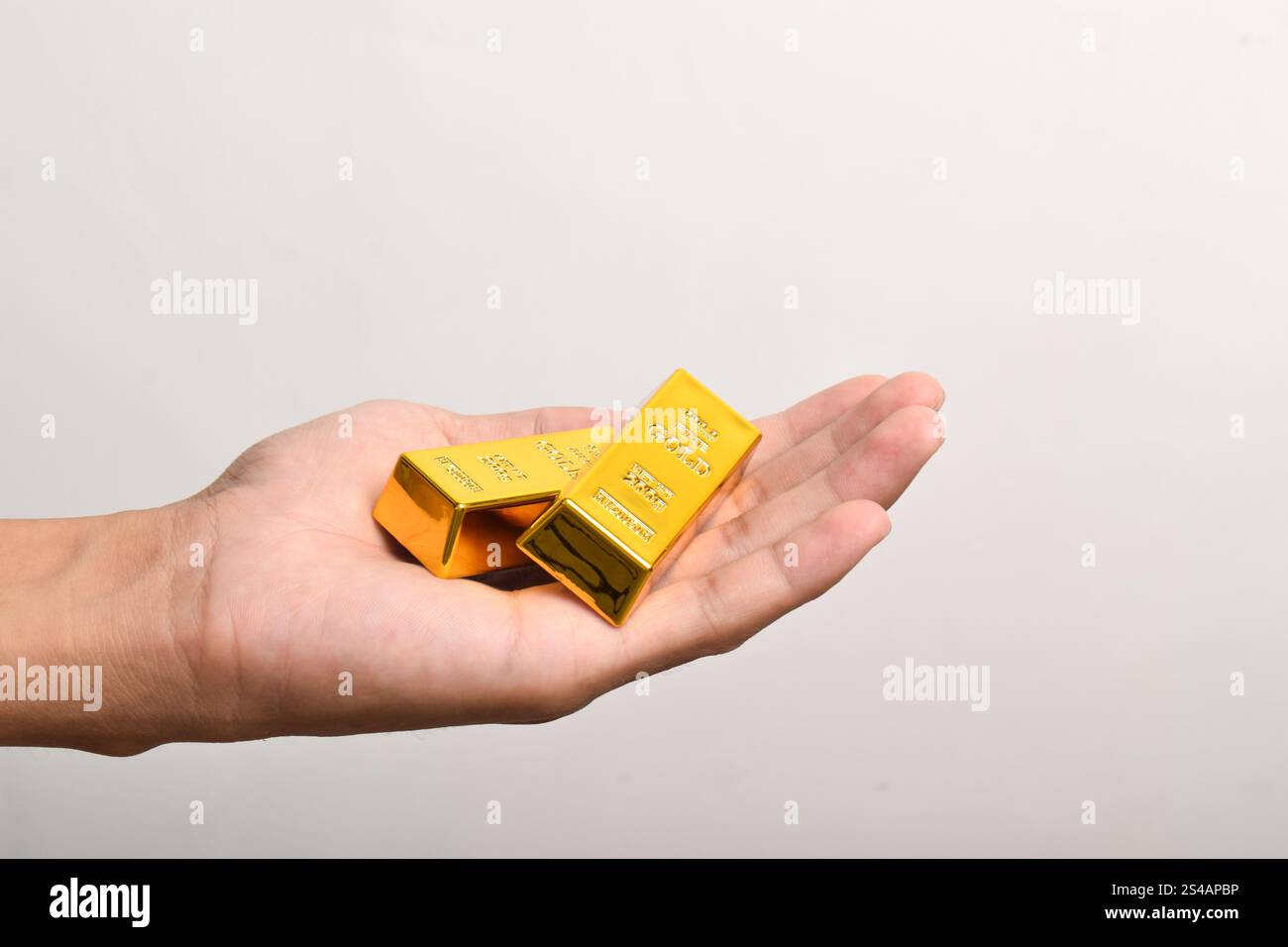 Hand holding gold bars on white background, closeup Stock Photo - Alamy
