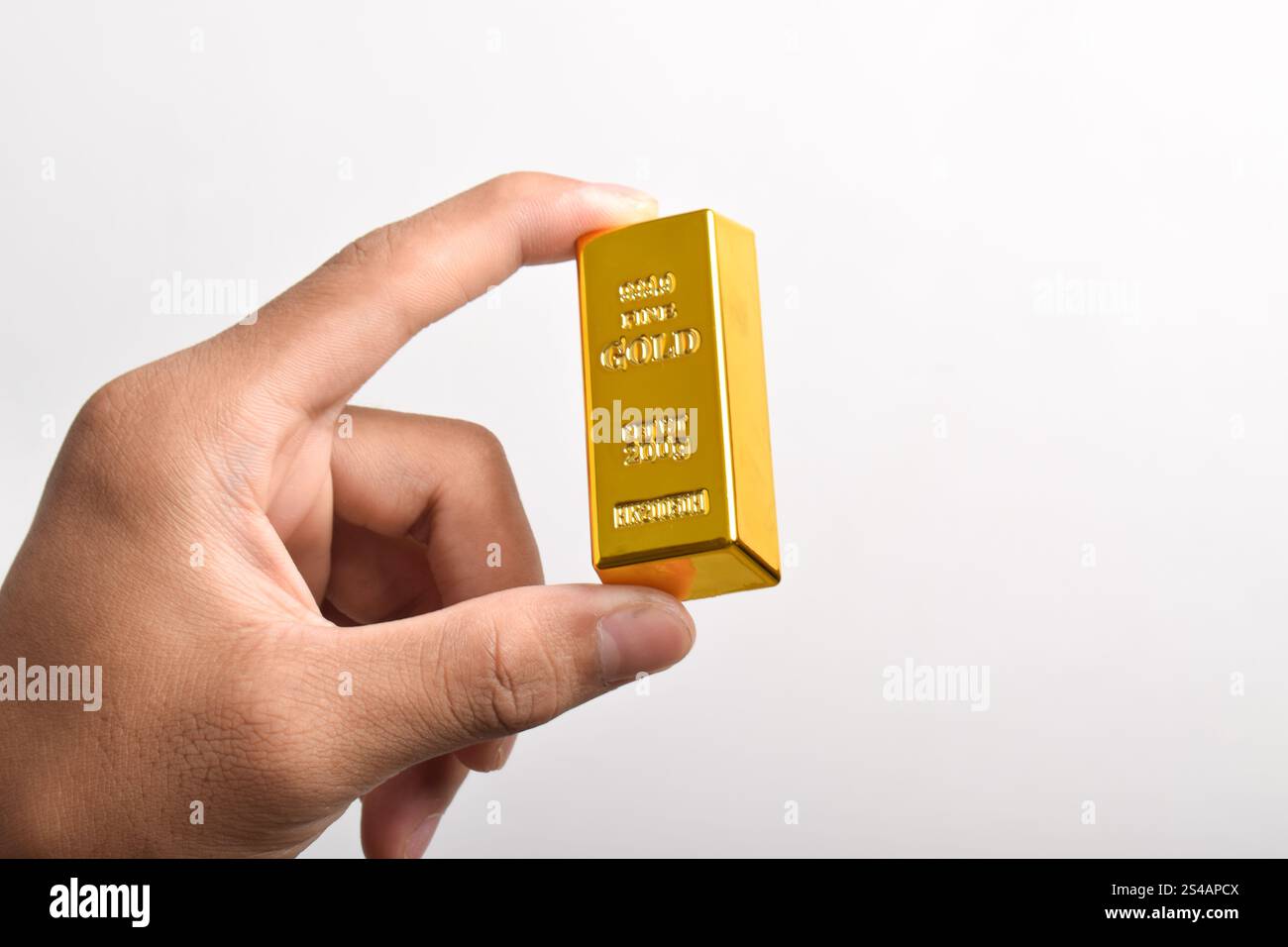 Hand holding gold bars on white background, closeup Stock Photo - Alamy
