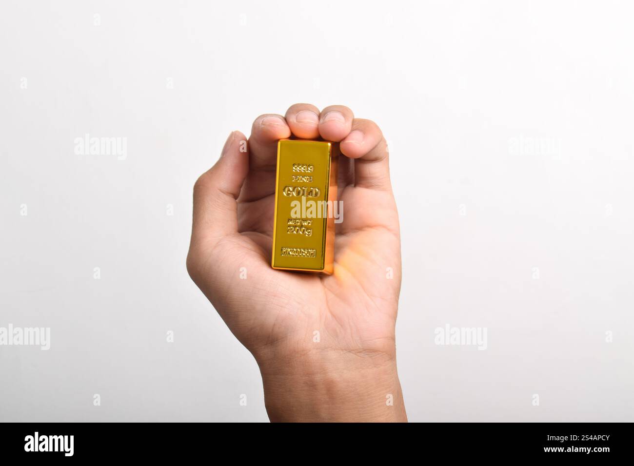 Hand holding Gold bar isolated on white background, with clipping path Stock Photo - Alamy
