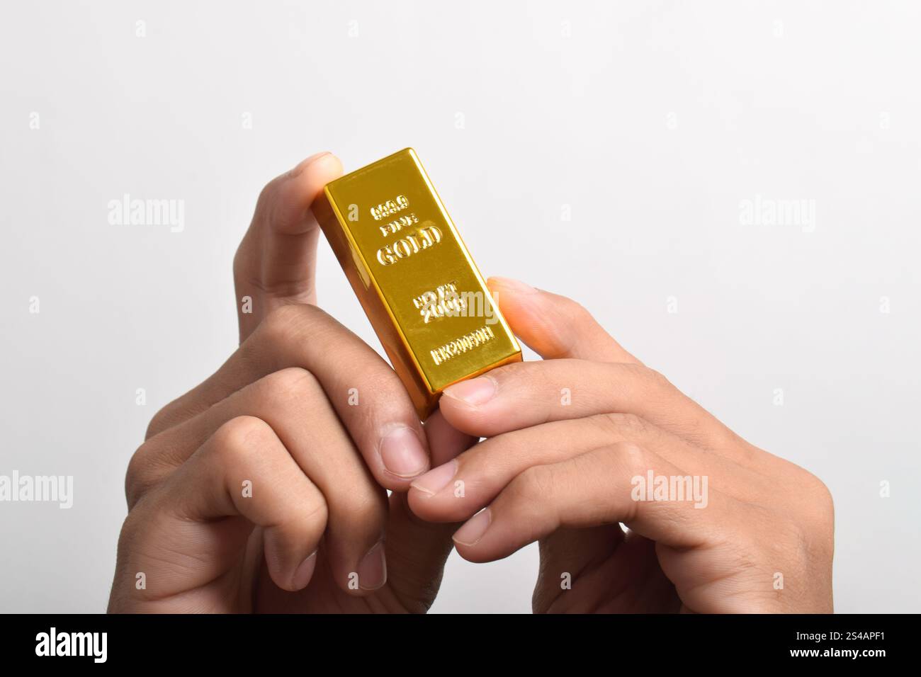 Hand holding Gold bar isolated on white background, with clipping path Stock Photo - Alamy
