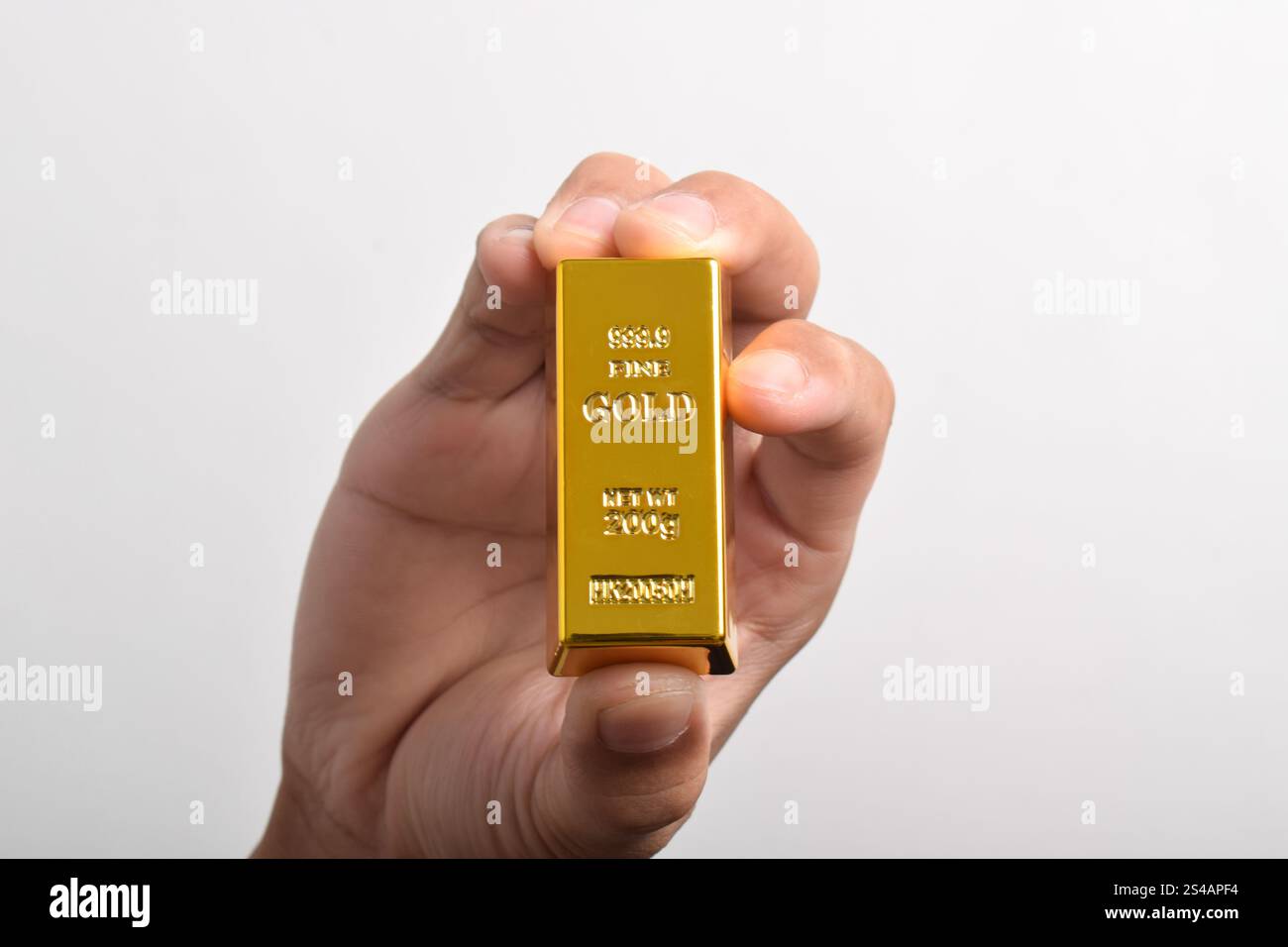 Hand holding Gold bar isolated on white background, with clipping path Stock Photo - Alamy