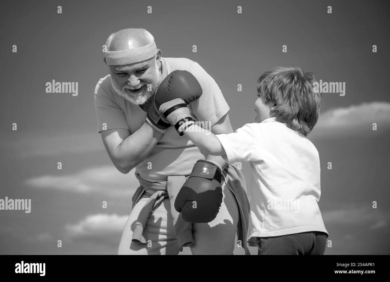 I love boxing. Funny cute child fighting. Grandpa and little child boy ...