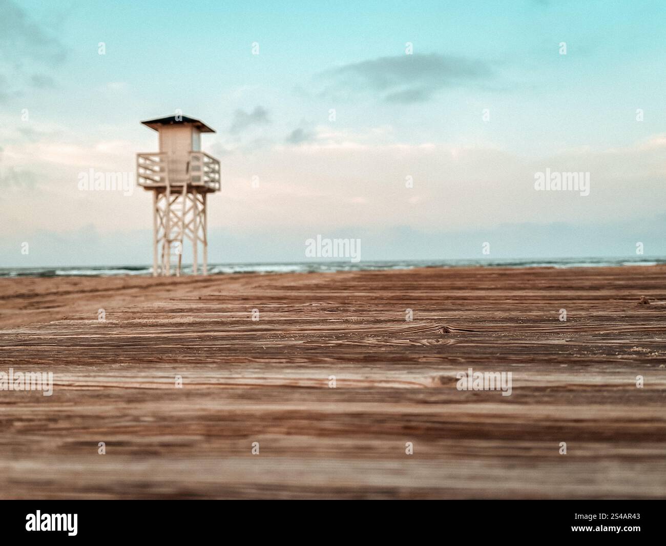 A white wooden lifeguard watchtower located on the beach. A rescue ...